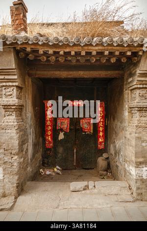 Chinese Entrance with Stone Columns and Wooden Door Stock Photo - Alamy
