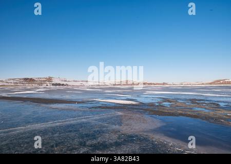Frozen Lake with Mountain Range and Village Stock Photo - Alamy