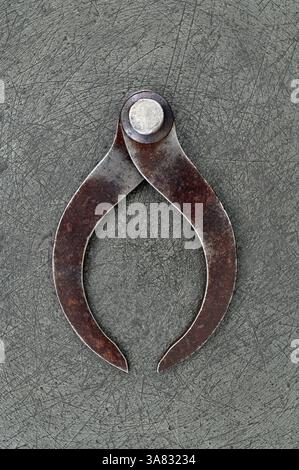 Old vintage well used calipers, made in Sheffield on wooden background ...