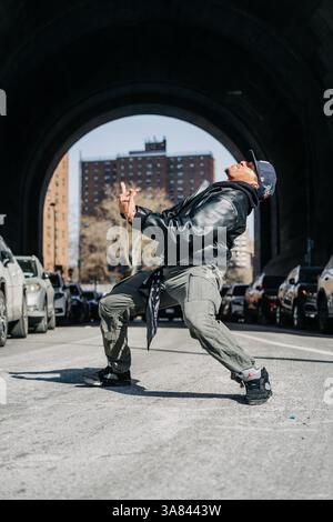 Street dancer leans back with power near graffiti-covered wall Stock ...