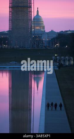 People walk along the Lincoln Memorial Reflecting Pool as workers clean ...
