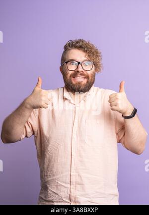 Crazy funny man showing double thumbs up on purple background ...
