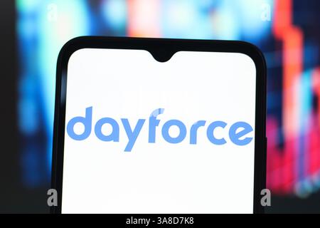 In this photo illustration, the Dayforce logo is seen displayed on a ...