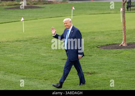 Prime Minister Mark Carney waves to people gathered nearby as he and MP ...