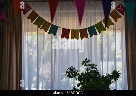 Happy birthday decoration over a window Stock Photo - Alamy