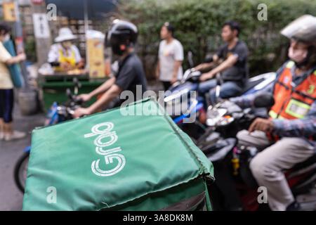 A Grab food delivery motorcycle seen parked on the busy streets Stock ...