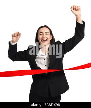 Happy businesswoman crossing red finish line ribbon on white background ...