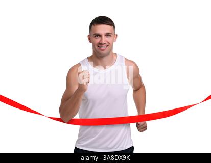 Happy sportsman crossing red finish line ribbon on white background ...