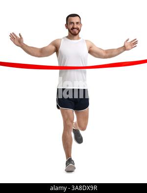 Happy sportsman crossing red finish line ribbon on white background ...