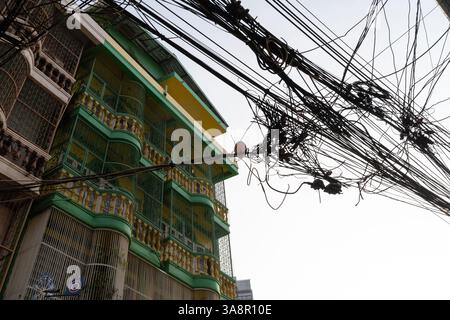A tangled mess of cables and wires used for phone and internet ...