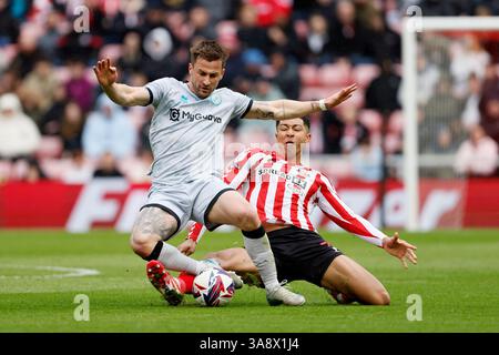 Millwall's Joe Bryan is fouled by Sunderland's Jobe Bellingham (right ...