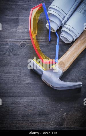 Vertical view blueprints hammer goggles on wood board Stock Photo - Alamy