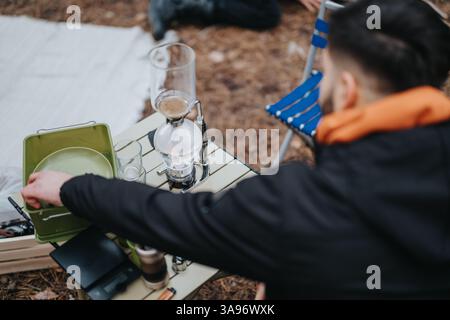 Outdoor coffee brewing setup with unique siphon equipment on a chilly ...