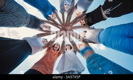 Students coming together in a circle, demonstrating unity, teamwork ...