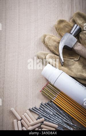Pair of protective gloves claw hammer nails hard hat on wood board ...