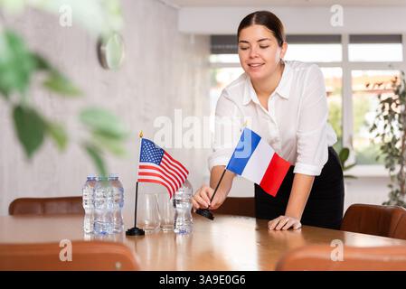 Female secretary places flags of the France and European Union flag on ...