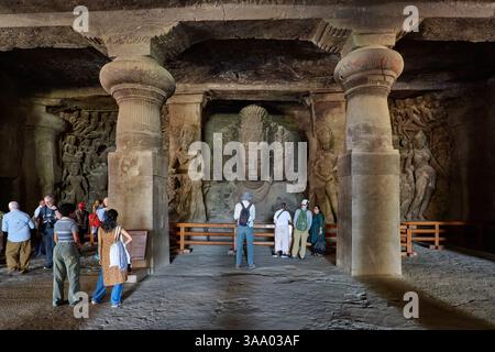 tourists in front of the Eternal Shiva, the Sadashiva, Elephanta caves ...