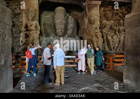 tourists in front of the Eternal Shiva, the Sadashiva, Elephanta caves ...