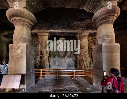 tourist in front of the Eternal Shiva, the Sadashiva, Elephanta caves ...