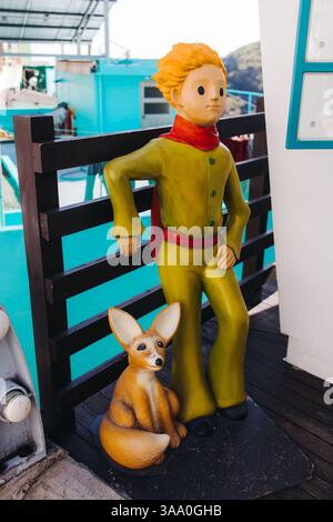 Little prince figure and fox statue with landscape cityscape of ...