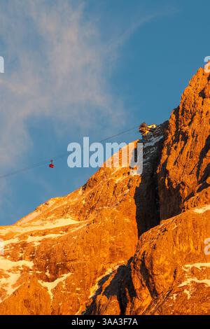 the red cabin of the Rosetta cable car on the Dolomite peaks of San ...
