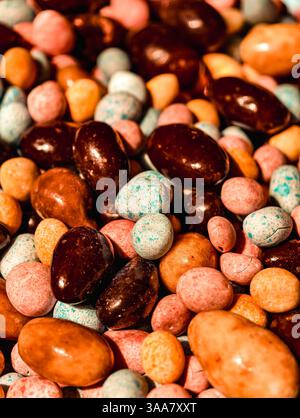 A macro shot of colorful candy drops isolated on a black background ...