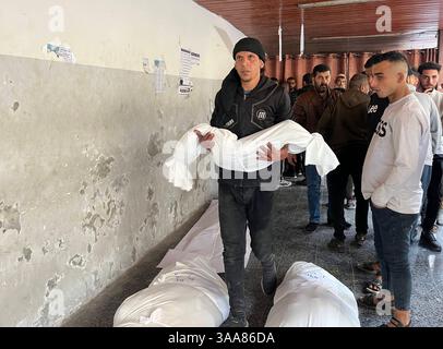 Palestinians mourn the deaths of nine members of the Hamada family at ...