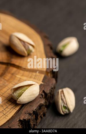fried pistachio nuts in their shells with added salt, fried unpeeled pistachio nuts with cracked ...
