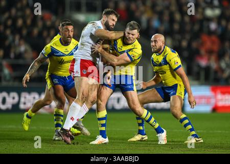 Alex Walmsley of St. Helens is tackled by Ed Chamberlain of Hull FC and ...