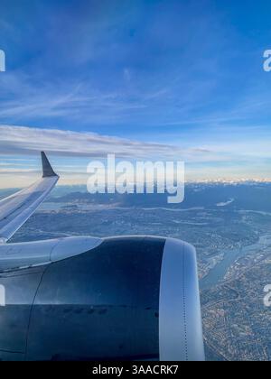 A closeup view of an airplane wing over the fluffy clouds Stock Photo ...