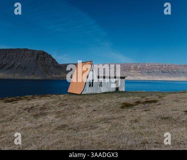 Abandoned A-frame barn near Fossfjordur fjord in Westfjords, Iceland ...