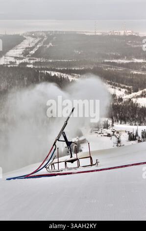 Snow cannon gun or machine sprays water and snowes a ski or cross ...
