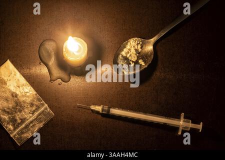 injection, candle and Heroine of a junkie Stock Photo - Alamy