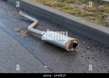 Exhaust pipe fallen of a junker car Stock Photo - Alamy