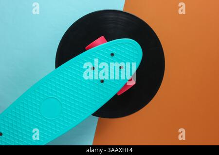 Cruiser board on vinyl record. Brown blue background. Youth retro style ...