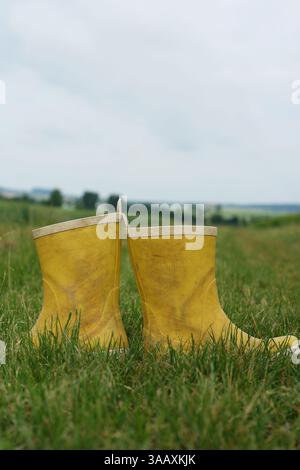 Yellow rubber boots left in the middle of field. Rubber Boots staying ...