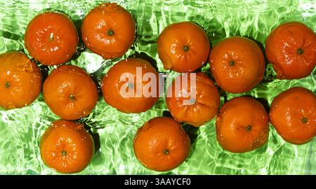 Long fruit banner, tangerines in water, splash of water, top view Stock ...