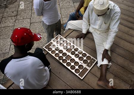 Bao players in Stone Town, Zanzibar. Bao is a traditional mancala board ...