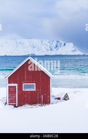Traditional red wooden hut by Ramberg beach, Lofoten, Norway Stock ...