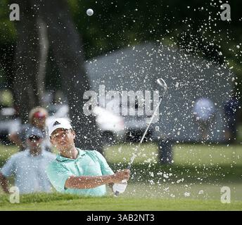 Xander Schauffele of the United States chips out of a bunker on the 7th ...