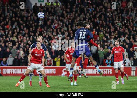 Patrick Dorgu of Manchester United heads the ball clear of his ...