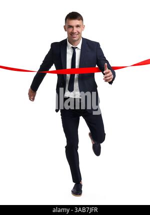 Happy businessman crossing red finish line ribbon on white background ...