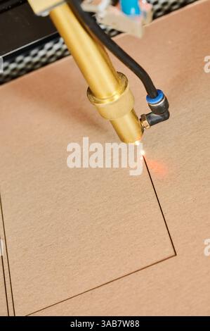 Precision laser cutting shapes cardboard sheets in a modern ...