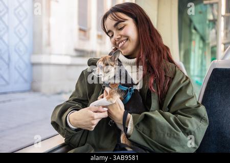 A woman smiles while holding a small red piece of fruit Stock Photo - Alamy