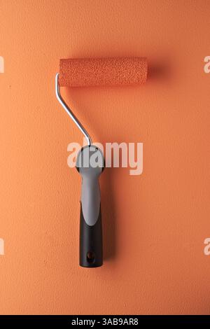 A paint roller on an orange surface with color samples Stock Photo - Alamy