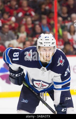 Winnipeg Jets left wing Kyle Connor, front, celebrates after scoring a ...