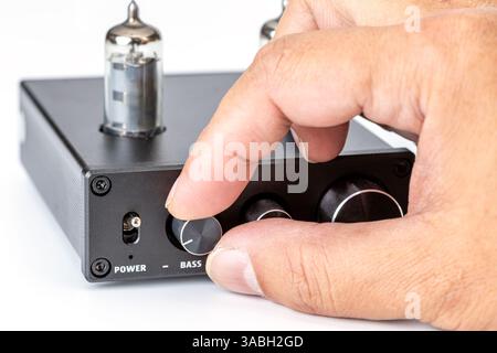 Fine tuning of a tube amplifier: Focused shot of a person adjusting the ...