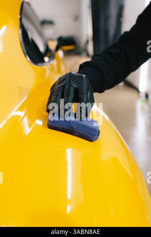 Process of applying a ceramic coating to the sports car surface for ...
