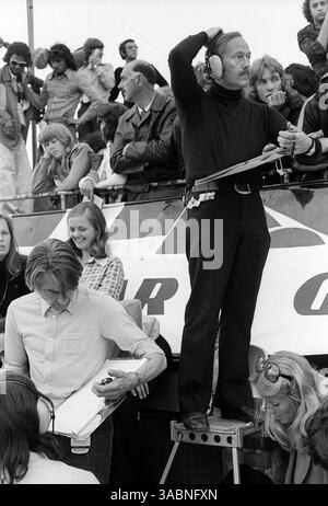 Colin Chapman (GBR) Lotus Team Owner (Far end) holds a Lotus team ...
