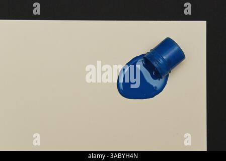 a large sheet of watercolor paper and a drop of blue pain Stock Photo ...